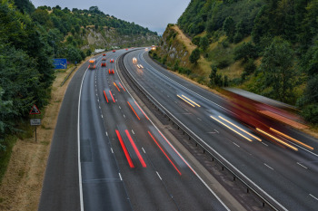 What colour are the reflective studs between a motorway and its slip road?