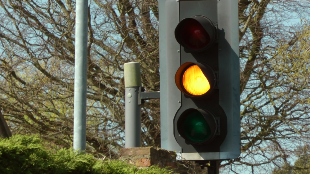 Driving lessons teaching a pupil to deal with traffic lights in the uk