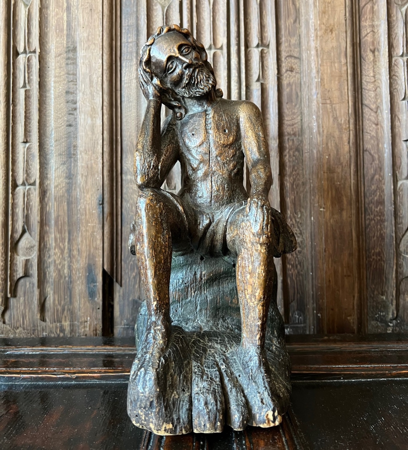 17th century carved figure of christ seated on the cold stone.
