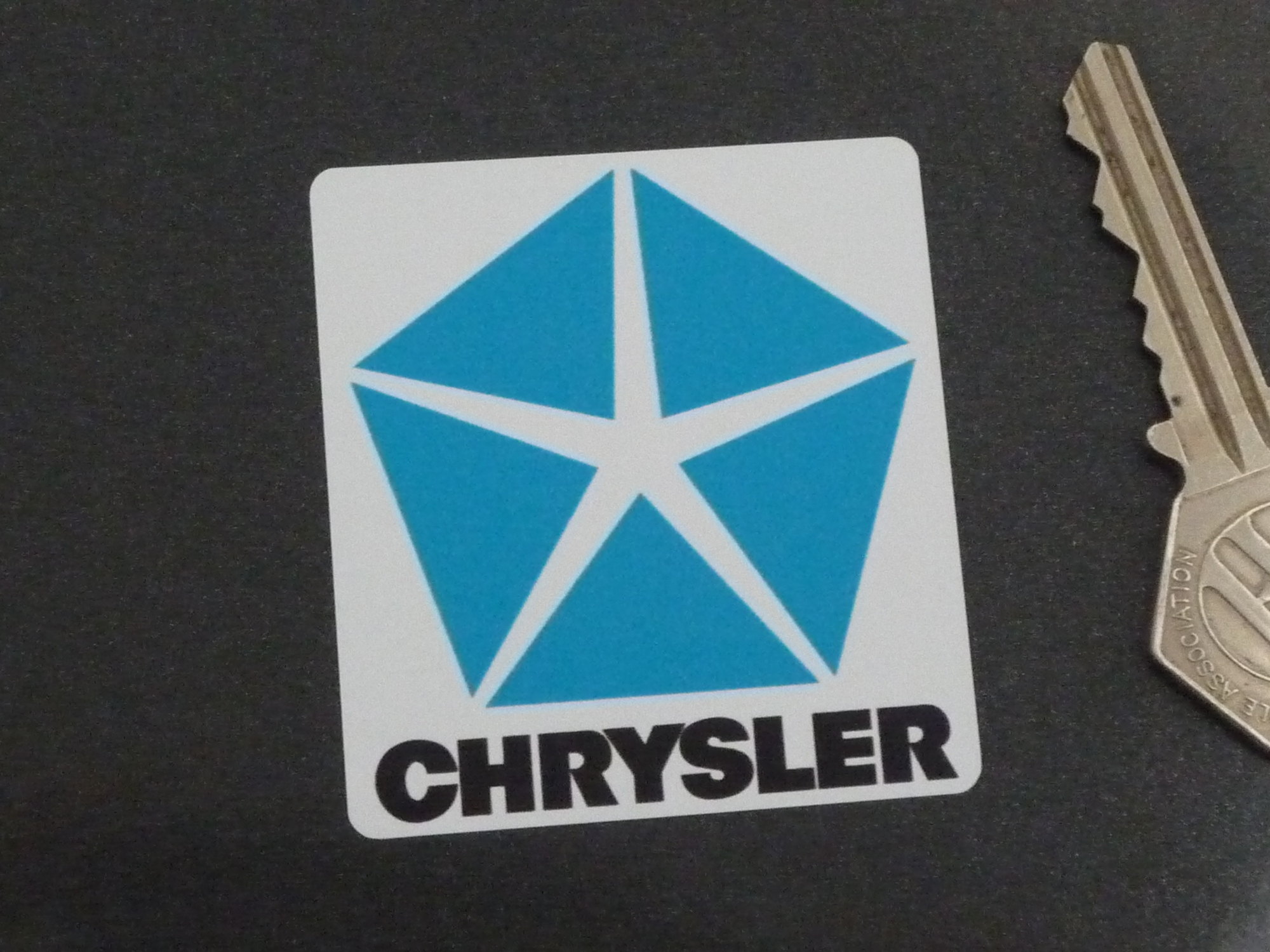 Chrysler 'Powered By' Wheel Sticker. 3.5".