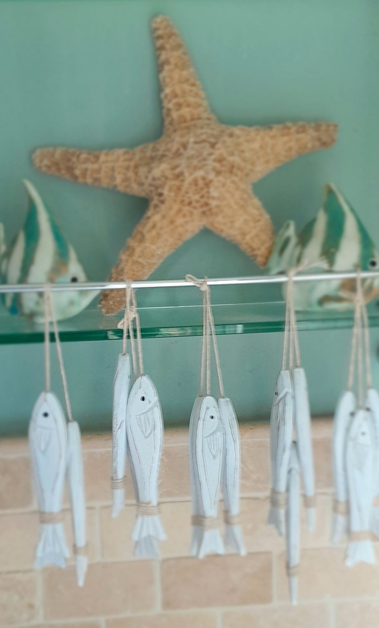 Wooden bunch of three hanging fish on string hanger