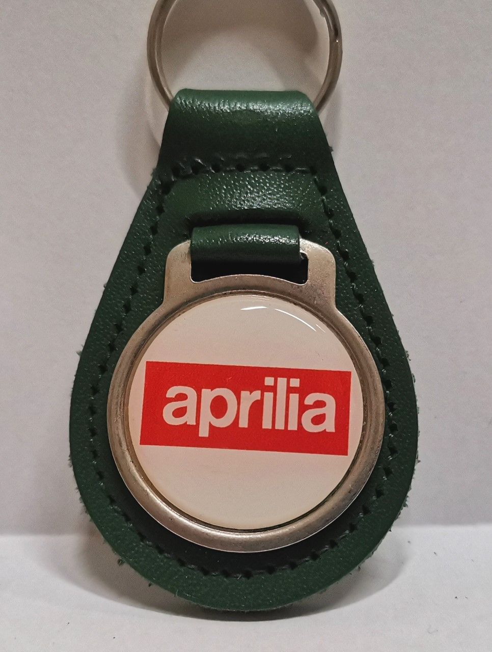 Aprilia acrylic badged green leather keyring.